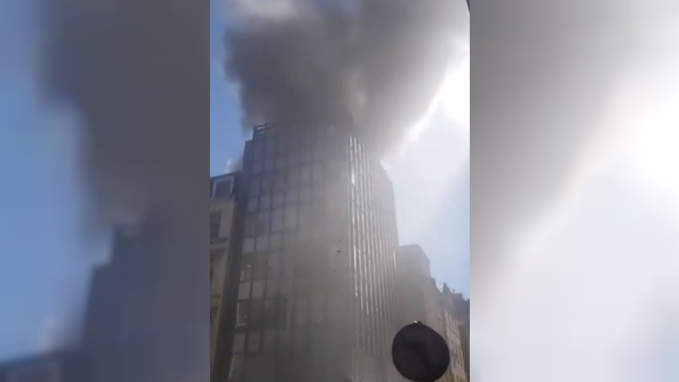 Smoke pours from London building as dozens of firefighters battle blaze ...